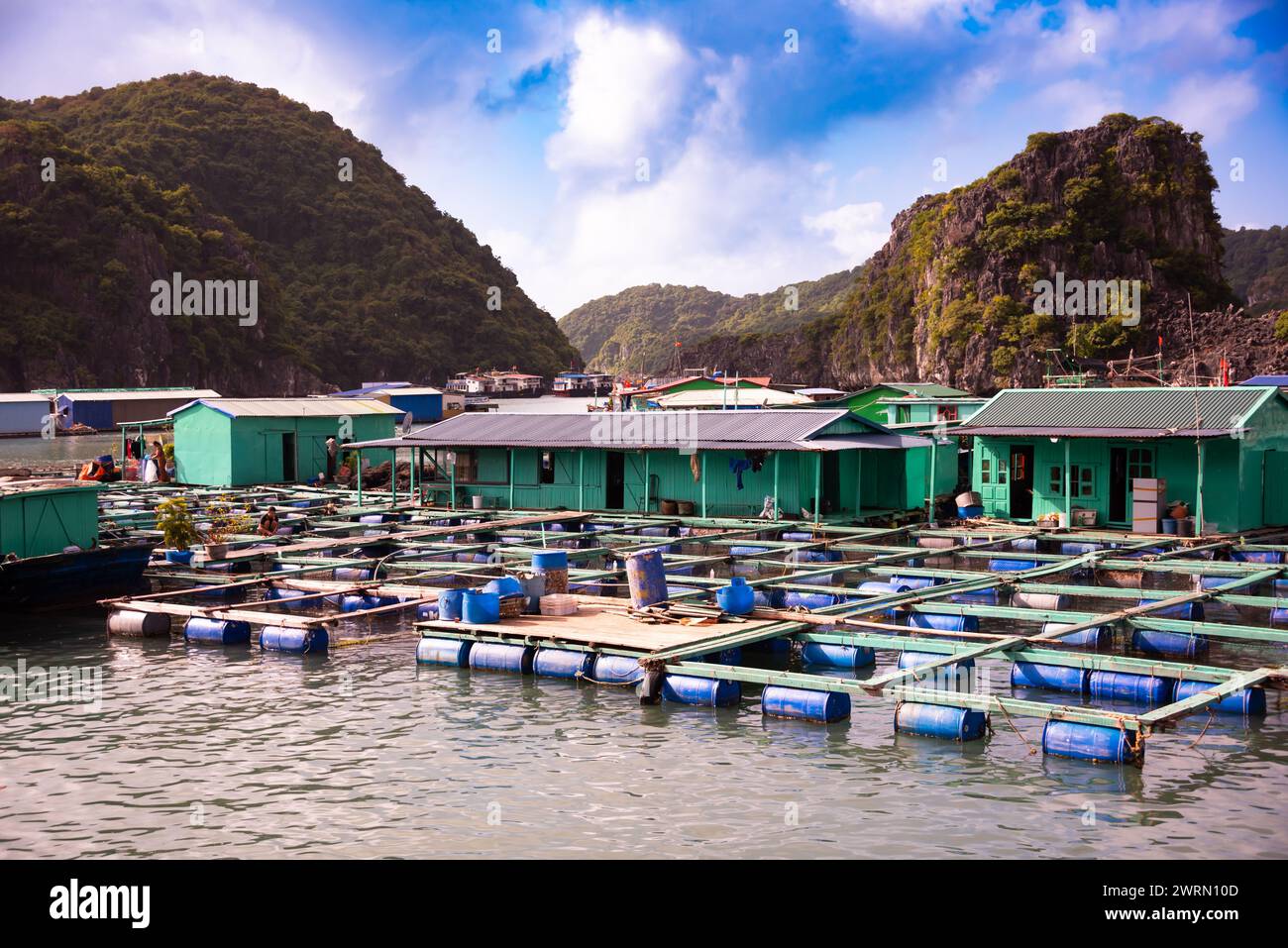 Floating village in sea bay in Vietnam Stock Photo - Alamy