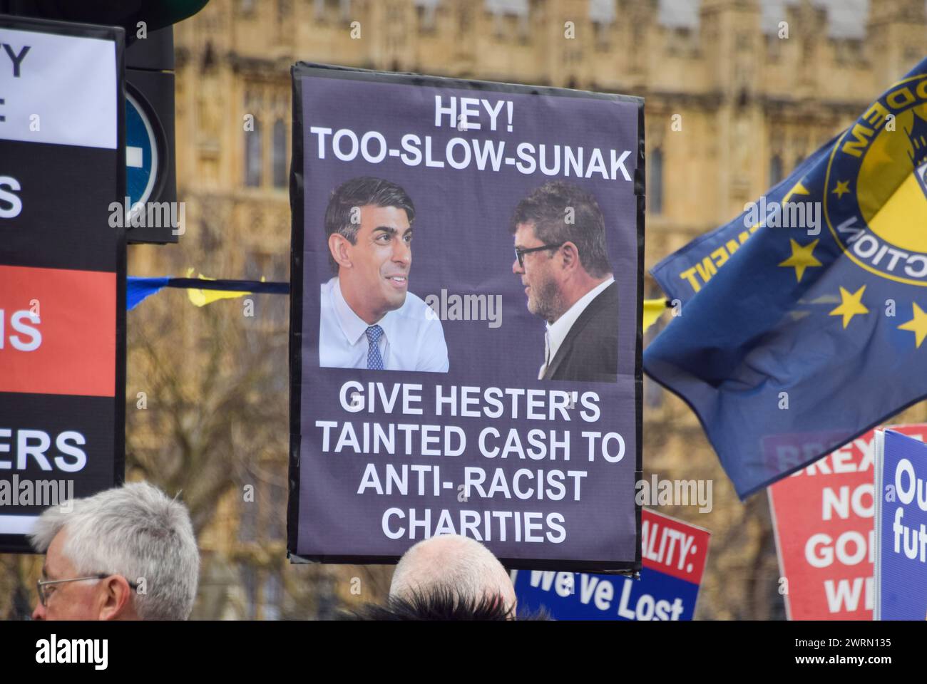 London, UK. 13th March 2024. A protester holds a placard referencing ...