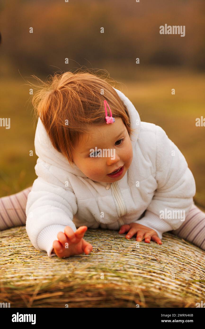 Curious toddler girl exploring nature's textures with focus and ...