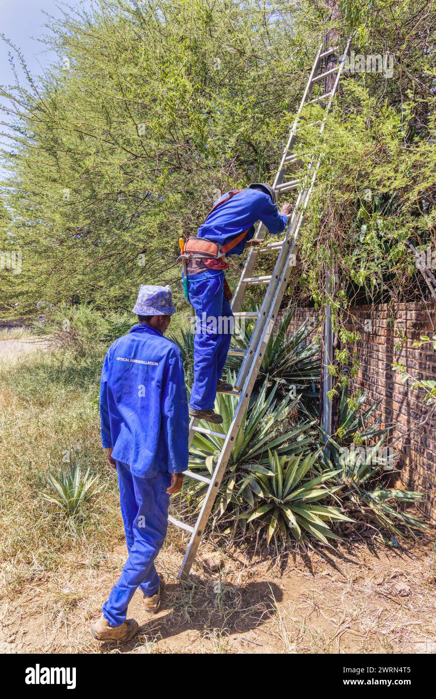 African workers for optical fiber installation, working outdoor ,they ...