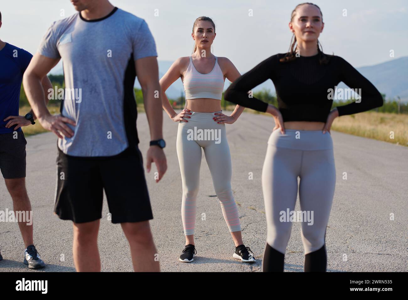 Diverse Athletic Warm-Up: Group Prepares for Intense Running Challenge ...