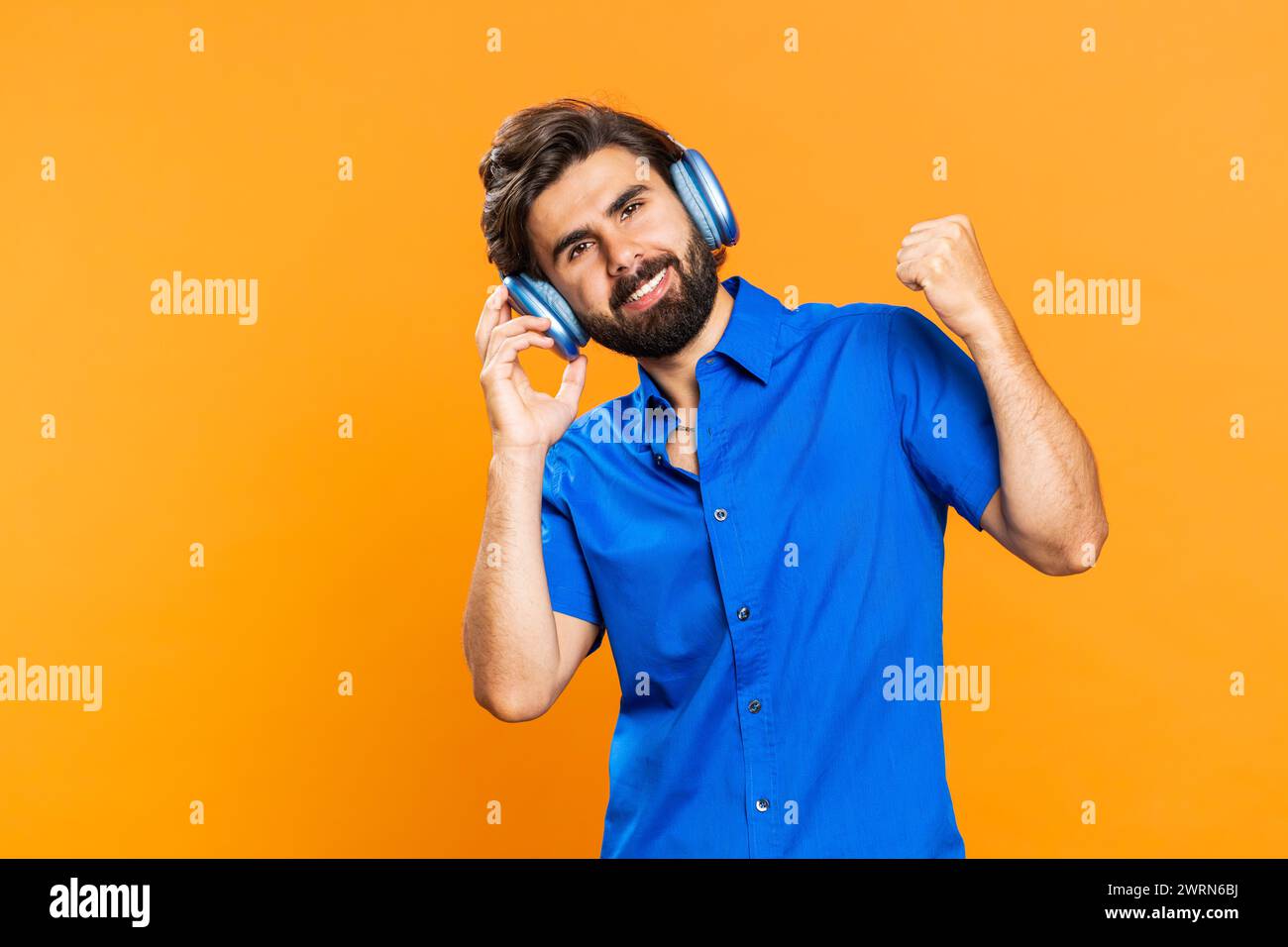 Happy man in headphones listening music and dancing disco fooling ...