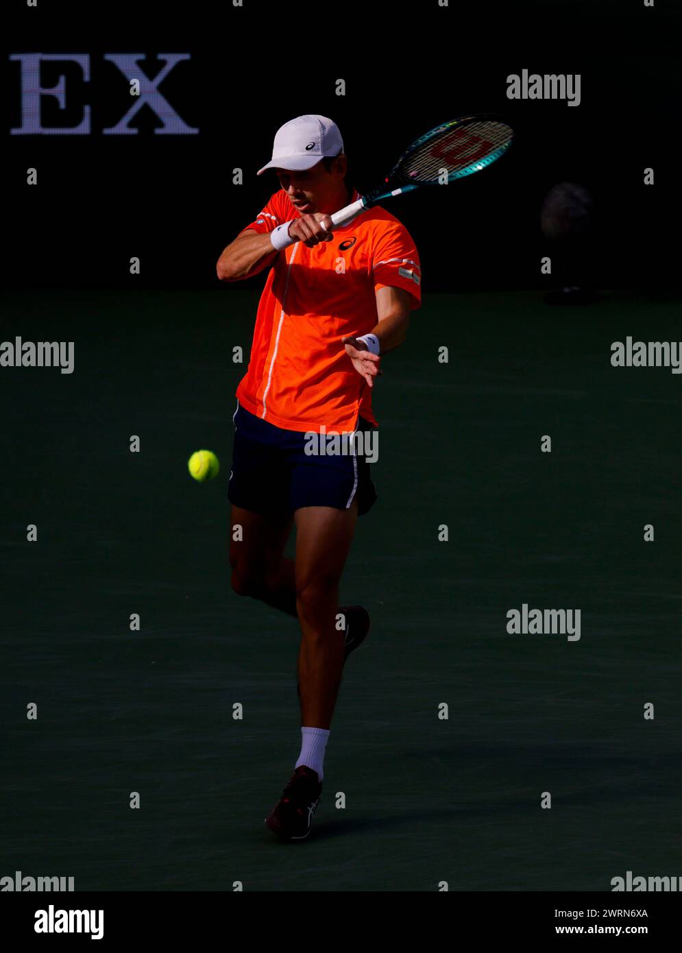 March 12, 2024 Alex De Minaur of Australia returns a shot against ...