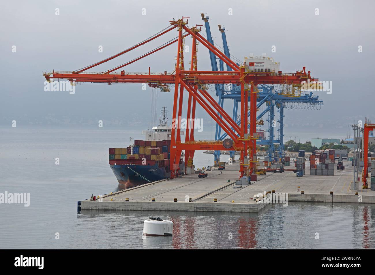 Container ship docked at port with gantry cranes loading containers hi ...
