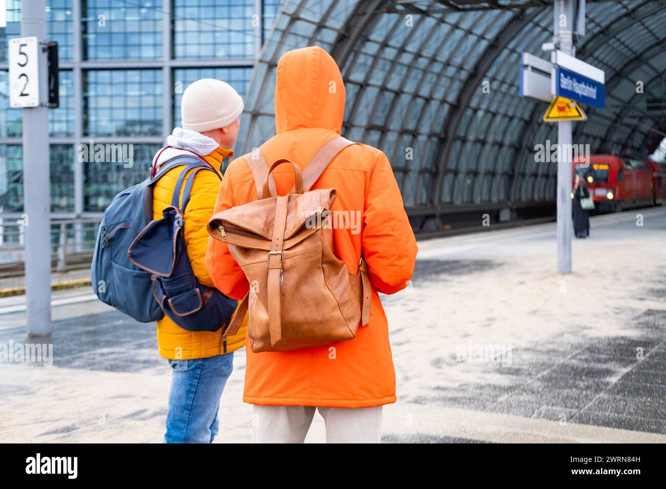 Passengers with backpacks wait for train at station, Berlin ...