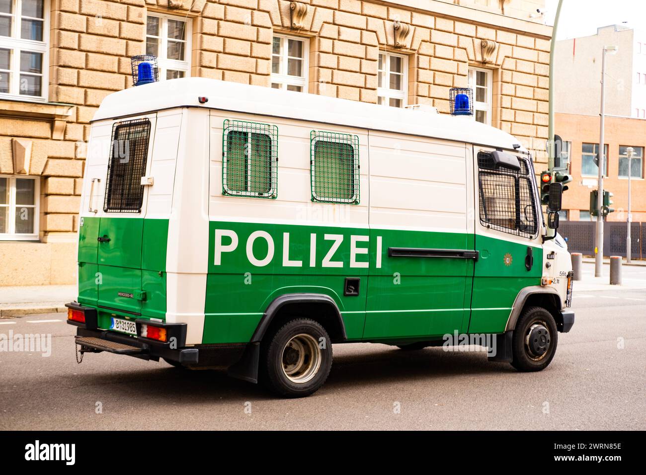 white and green police bus parked on street in Berlin, symbol law and ...