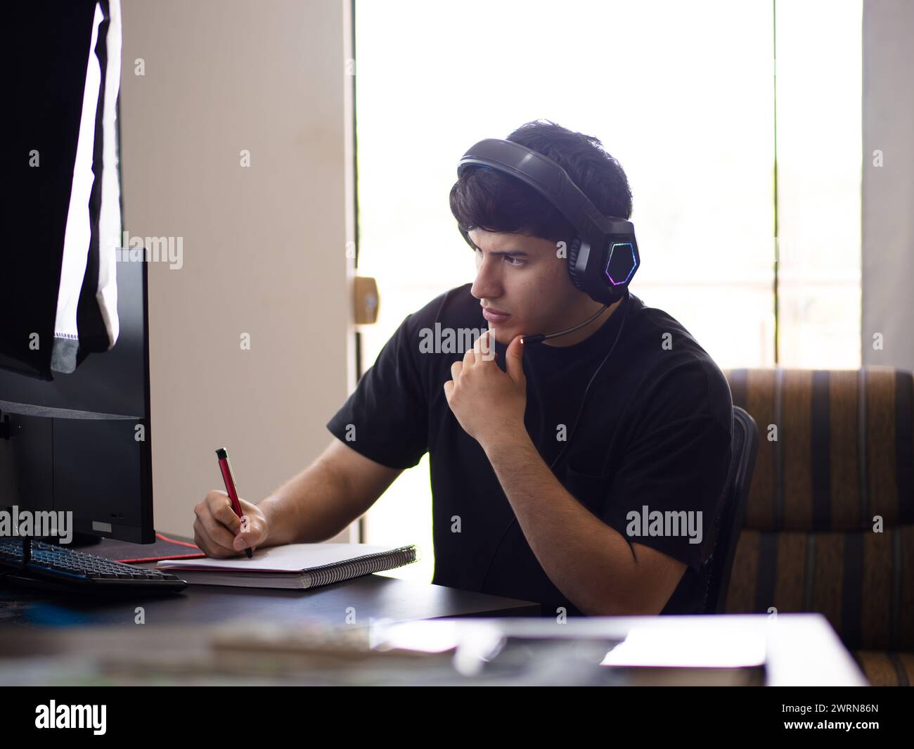 Image of a concentrated young man participating in a live broadcast ...