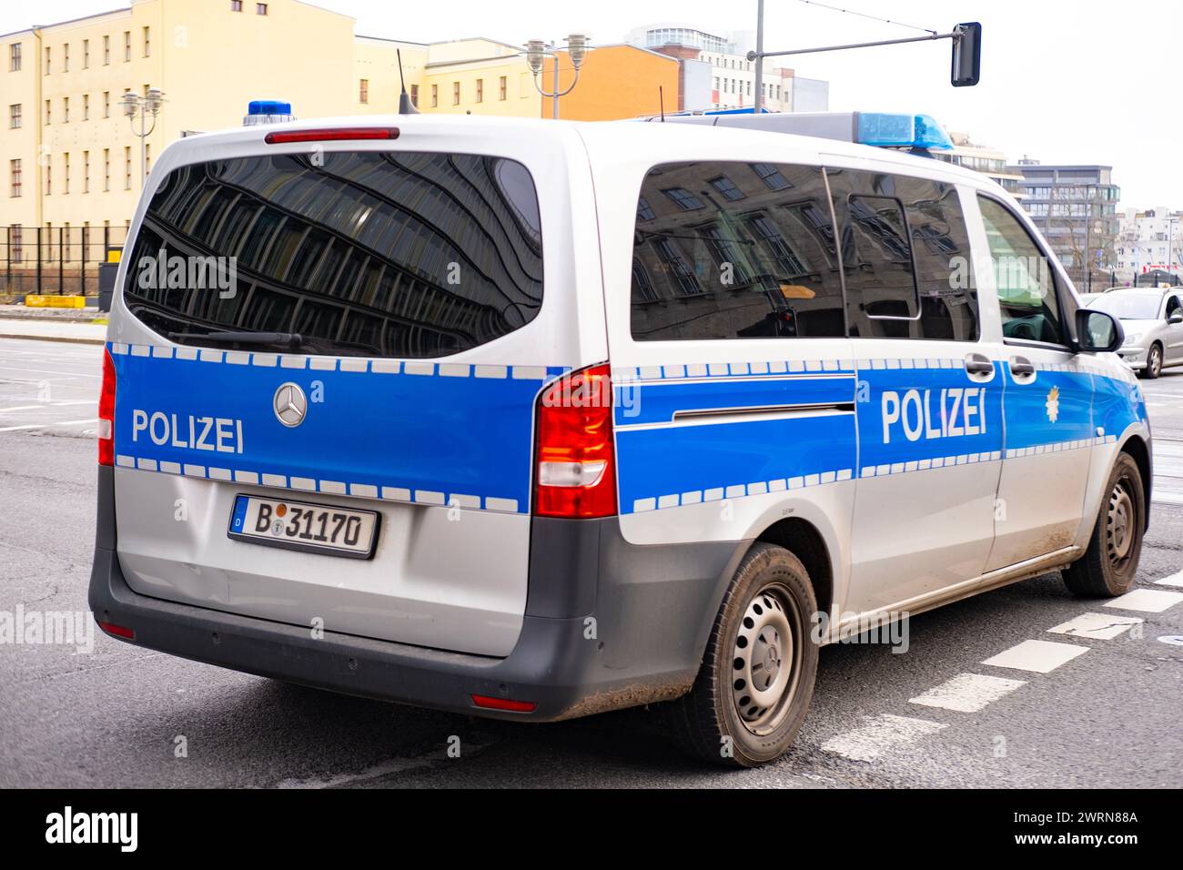 white and blue police bus parked on street in Berlin, symbol law and ...