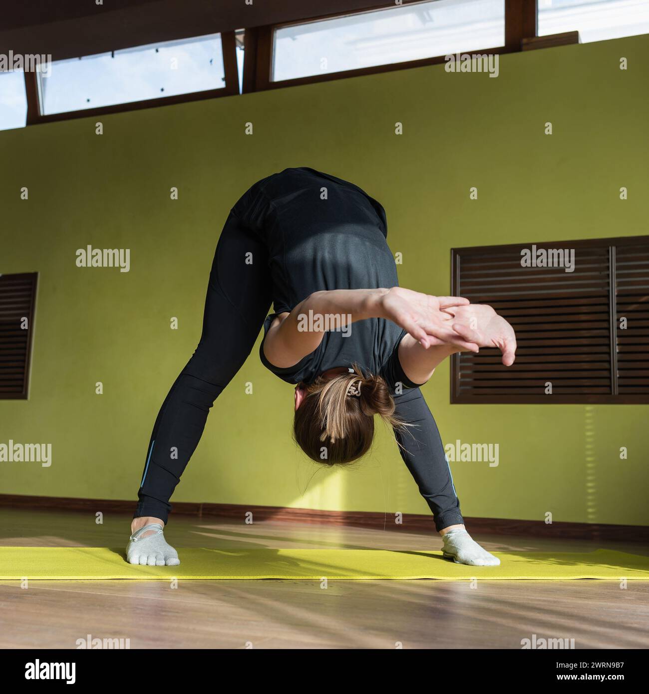Athletic Young Woman Performs Dandayamana Mudrasana Exercise Variation ...