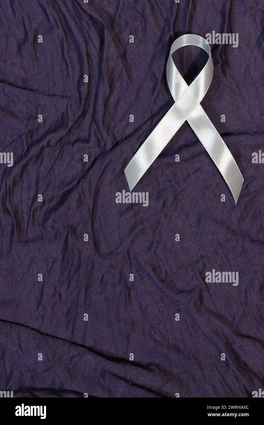 Gray ribbon on purple background Stock Photo - Alamy