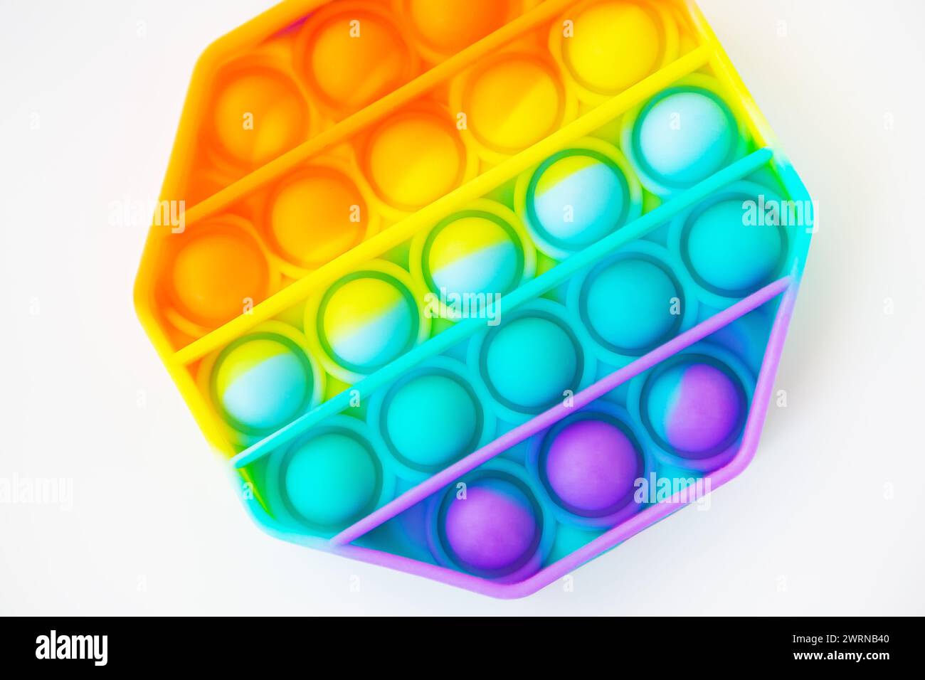 A colorful pop it fidget toy against a white background. The hexagonal ...
