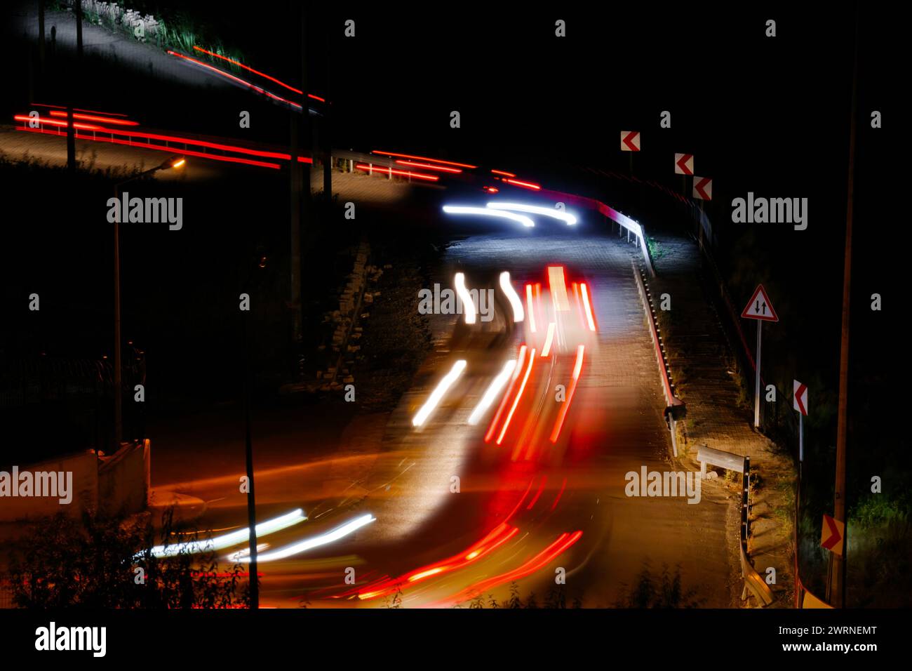View of fast moving cars traffic, light trails along the dark road at ...