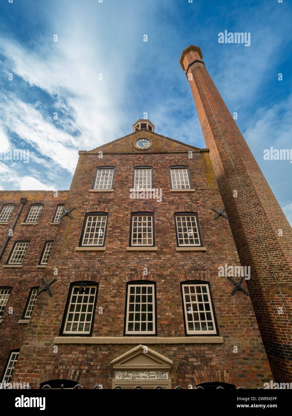 Exterior facade of Quarry Bank Mill with its octagonal chimney. Styal ...