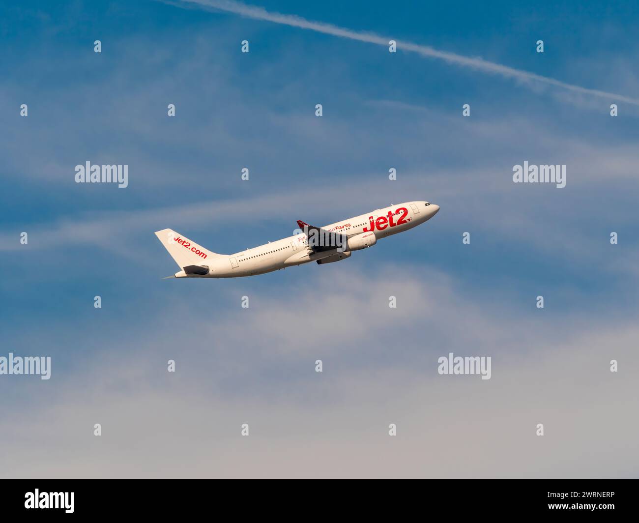 Jet2 Airbus A330-243 mid-air seen against a blue sky over Cheshire. UK ...