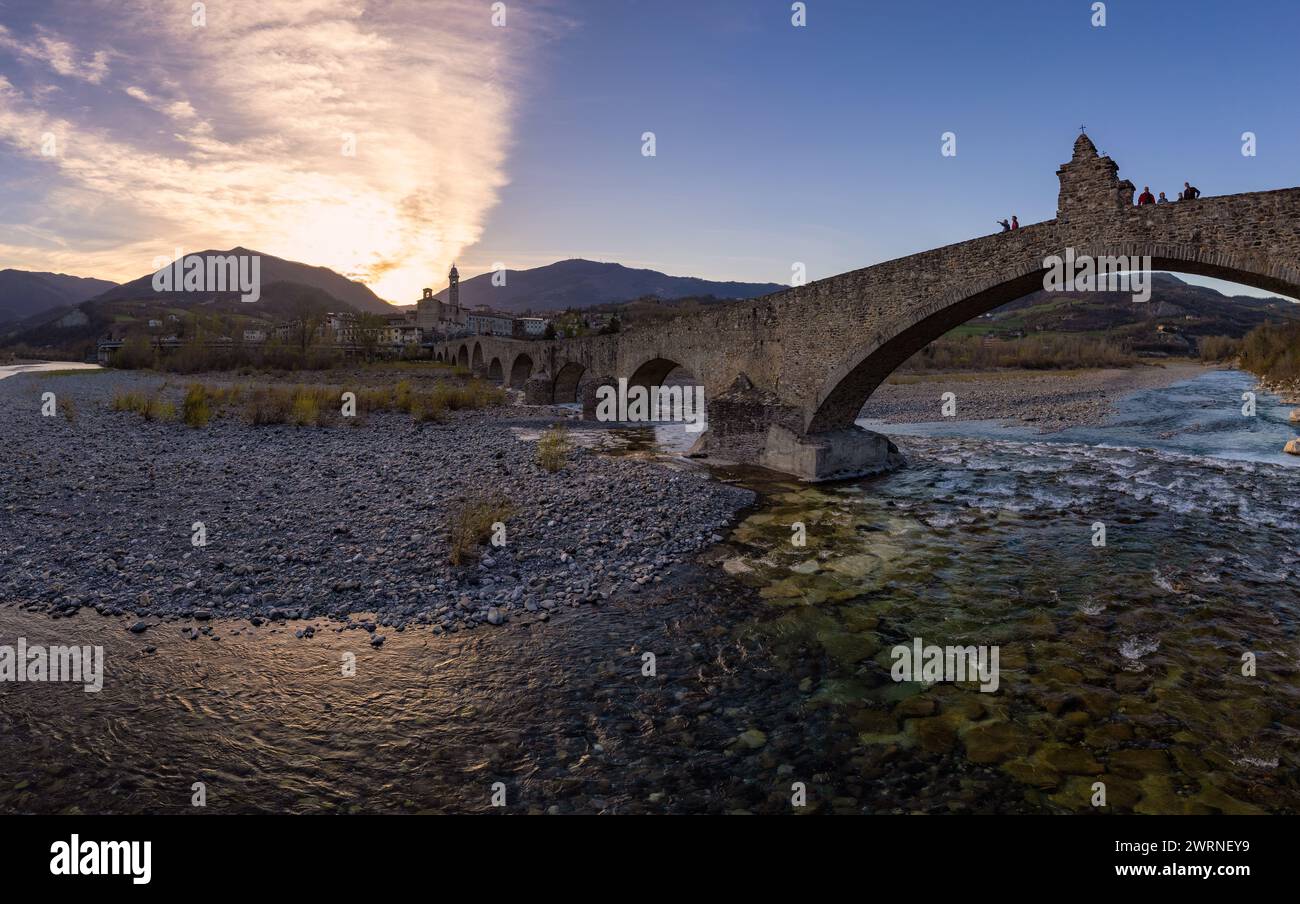 Aerial view of Bobbio town and Gobbo Bridge of Devil at sunset. Trebbia ...