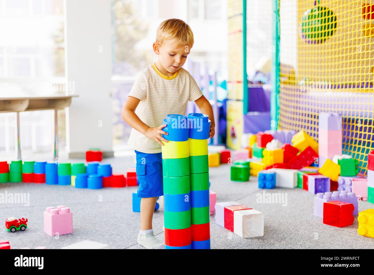 Child playing in color blocks hi-res stock photography and images - Alamy