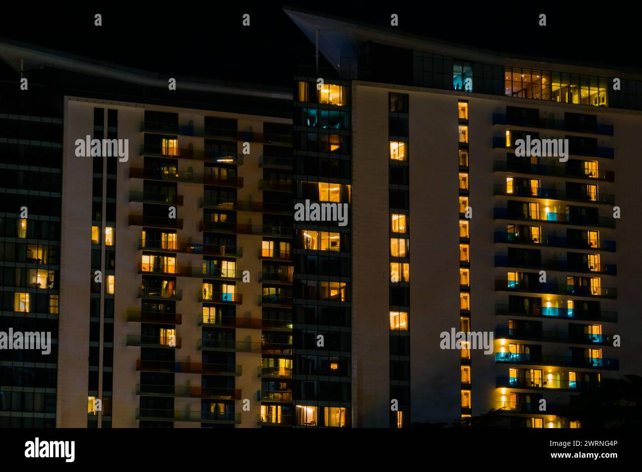 View of living hotel apartment building windows at night - facade view ...