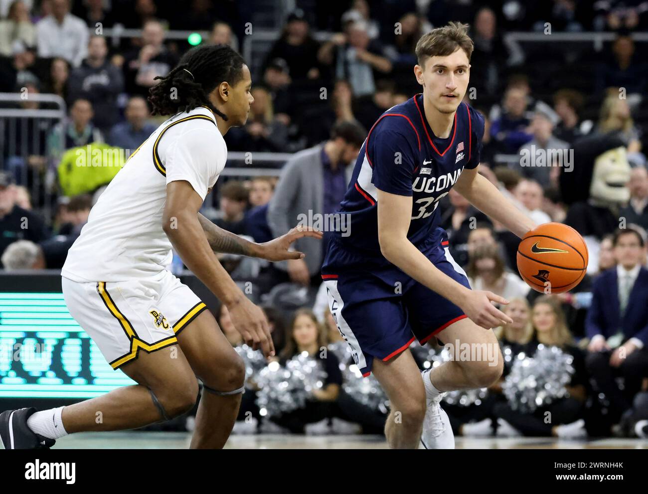 UConn guard Apostolos Roumoglou, right, defends the ball from ...