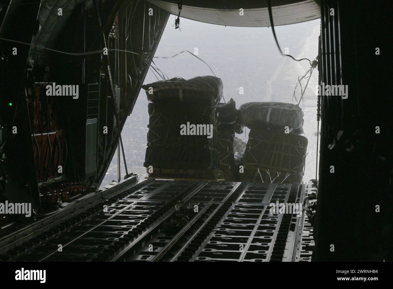 Gaza, Israel. 11 March, 2024. Pallets of humanitarian aid drop from the ...