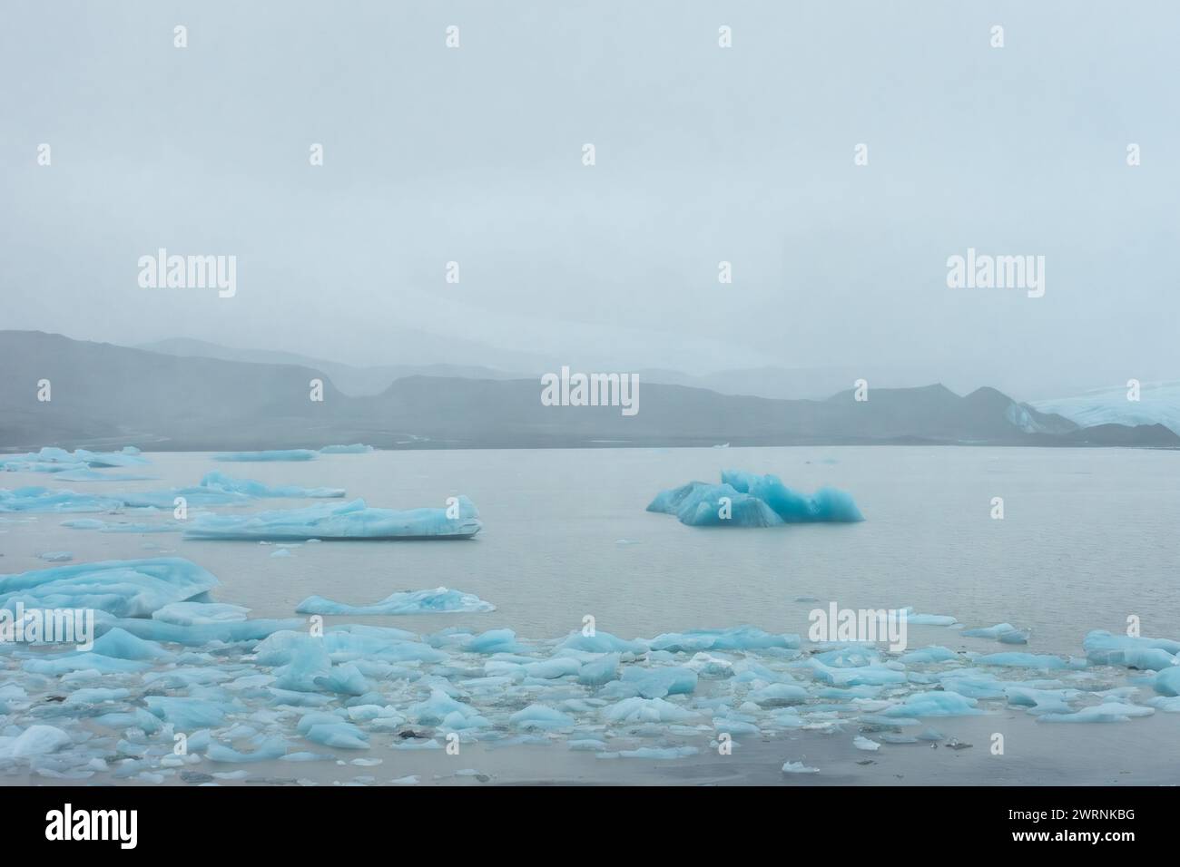 Icebergs from the melting Fjallsjokull Glacier under the rain, Iceland ...