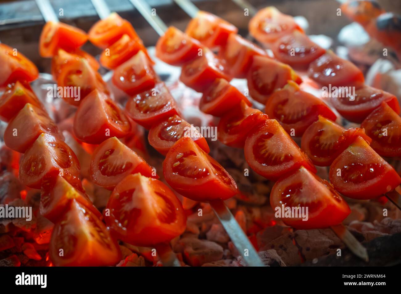 Barbecue with ripe red tomatoes on flamed charcoal grill in turkish ...
