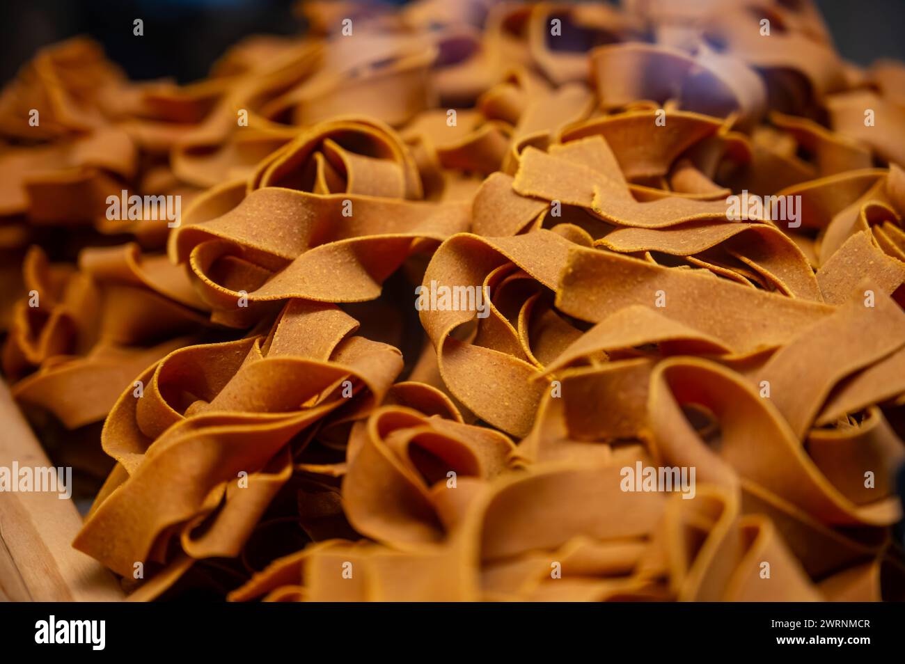 Italian food, dried handmade colorful pasta pappardelle with red ...
