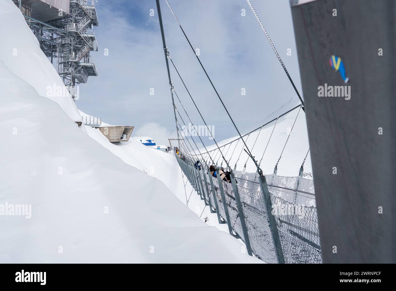 Winter Adventure on a Snowy Suspension Bridge in Engelberg, Switzerland ...