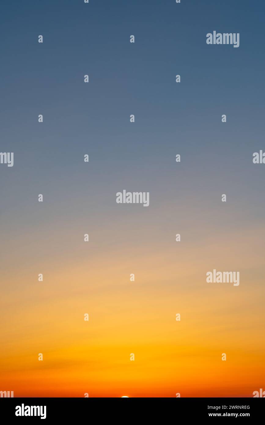 Sunrise sky with an orange-to-blue gradient Stock Photo - Alamy