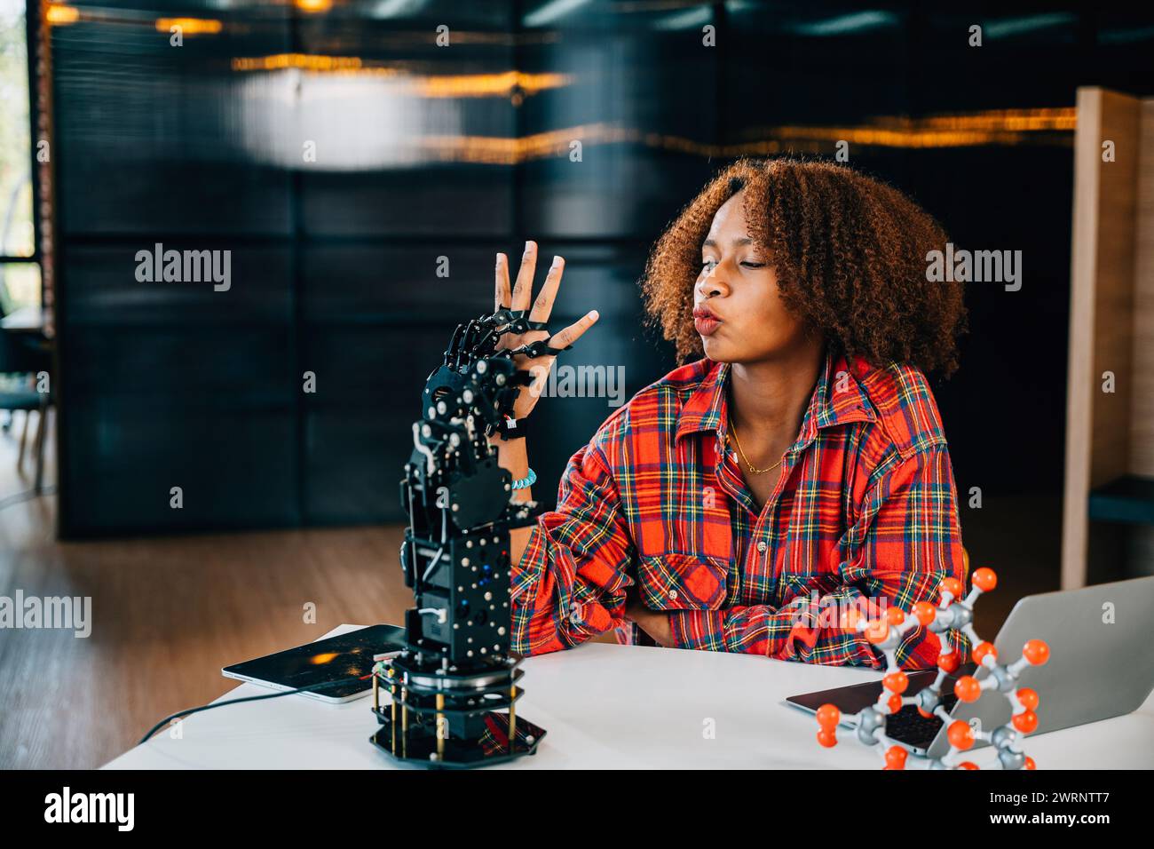 In a classroom a smart teenager experiments with a humanoid robotic ...