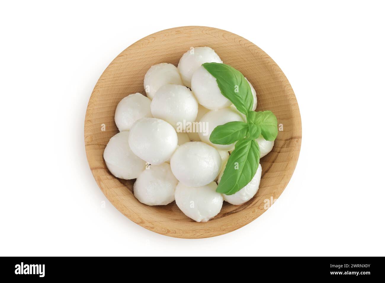 Mini mozzarella balls with basil in a wooden bowl isolated on white ...