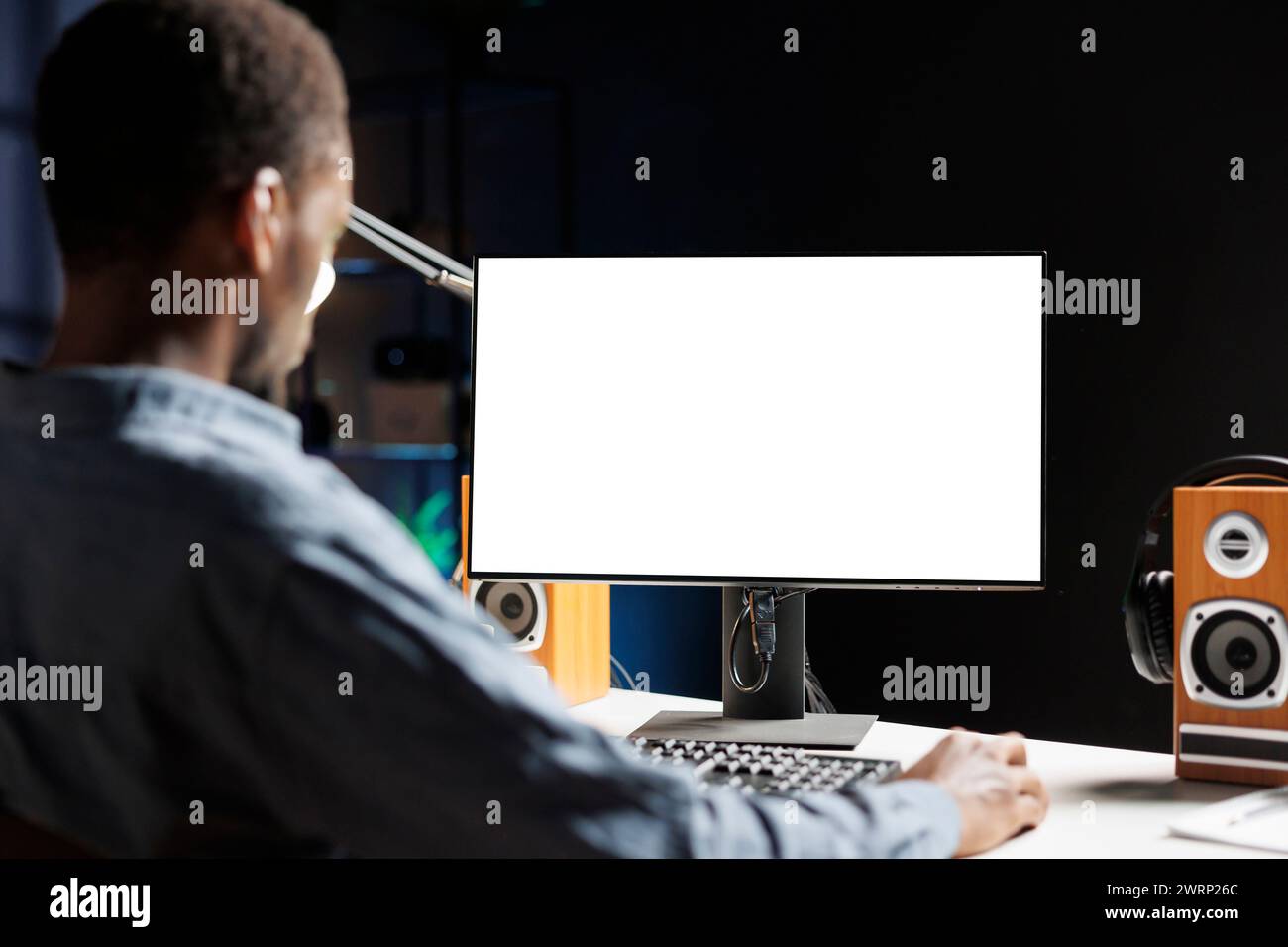 Man examines white display on workstation while telecommuting and uses ...