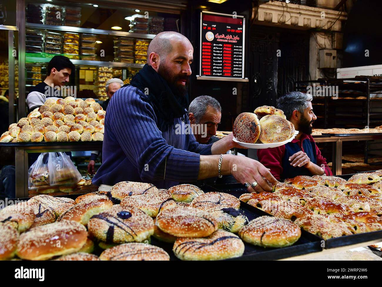 Damascus, Syria. 13th Mar, 2024. People shop for Maarouk sweets ...