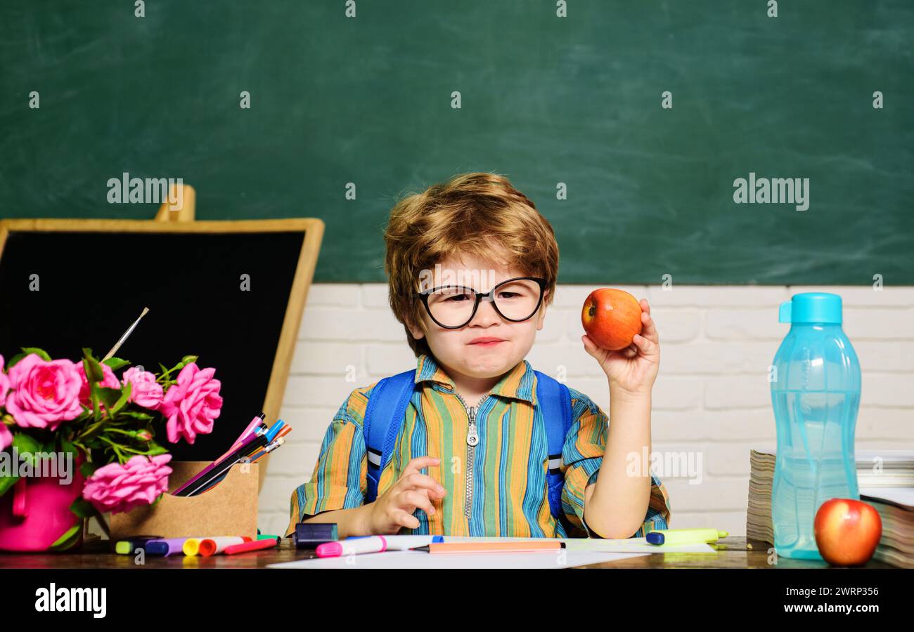 Little child boy eating apple having lunch break. Healthy school meal ...