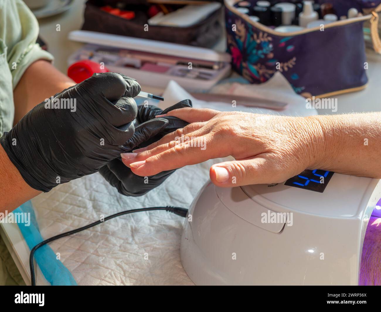 Manicure woman applying cuticle oil after removing old polish for ...