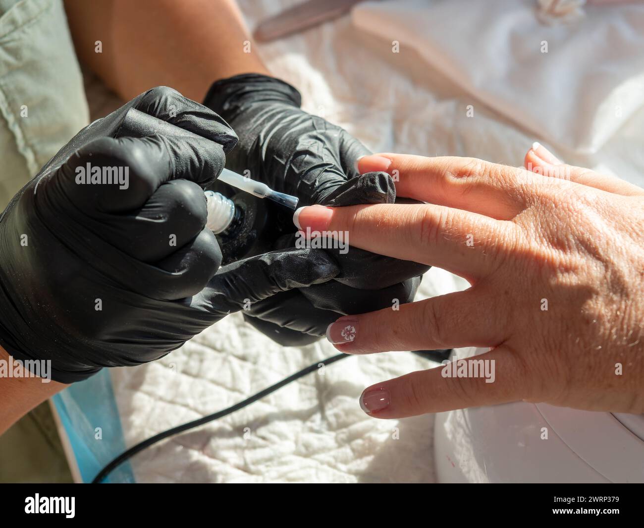 Manicurist makes female manicure hi-res stock photography and images ...