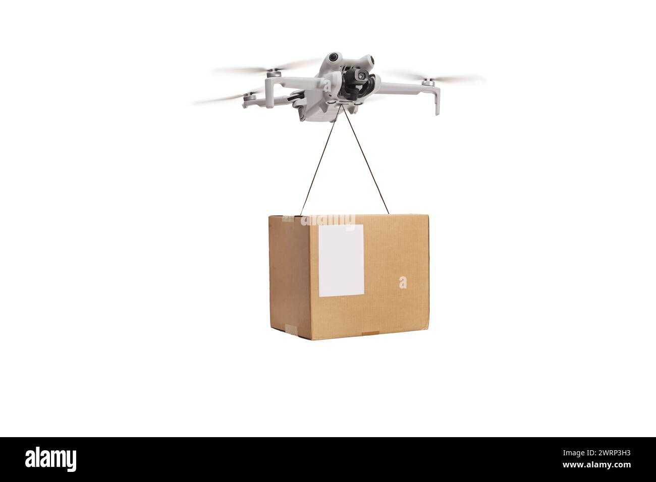 Aerial drone delivering a cardboard box isolated on white background ...