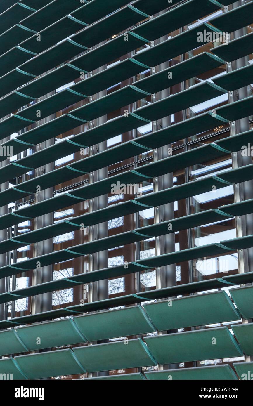 Modern glass facade with metallic sun shades, close up architectural ...
