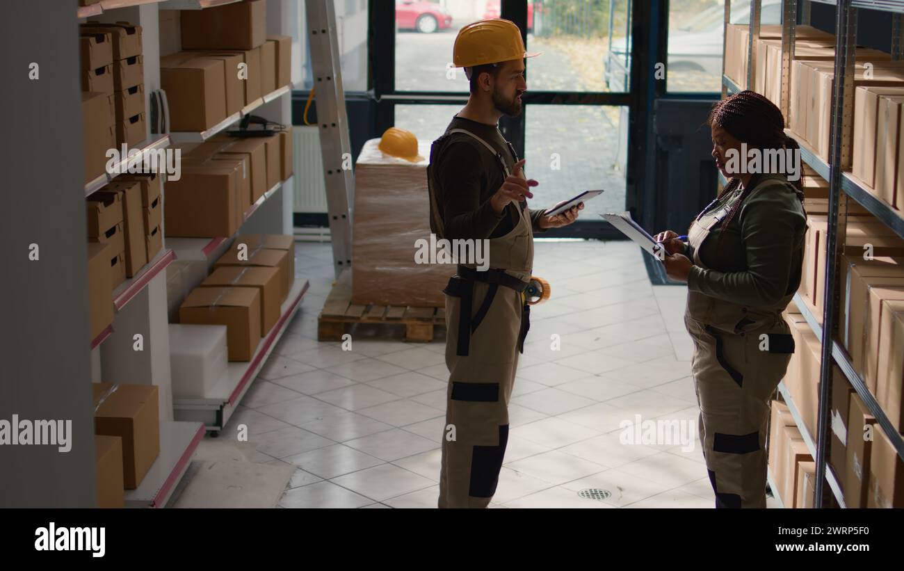 Employees in warehouse inputing updated products info on online ...