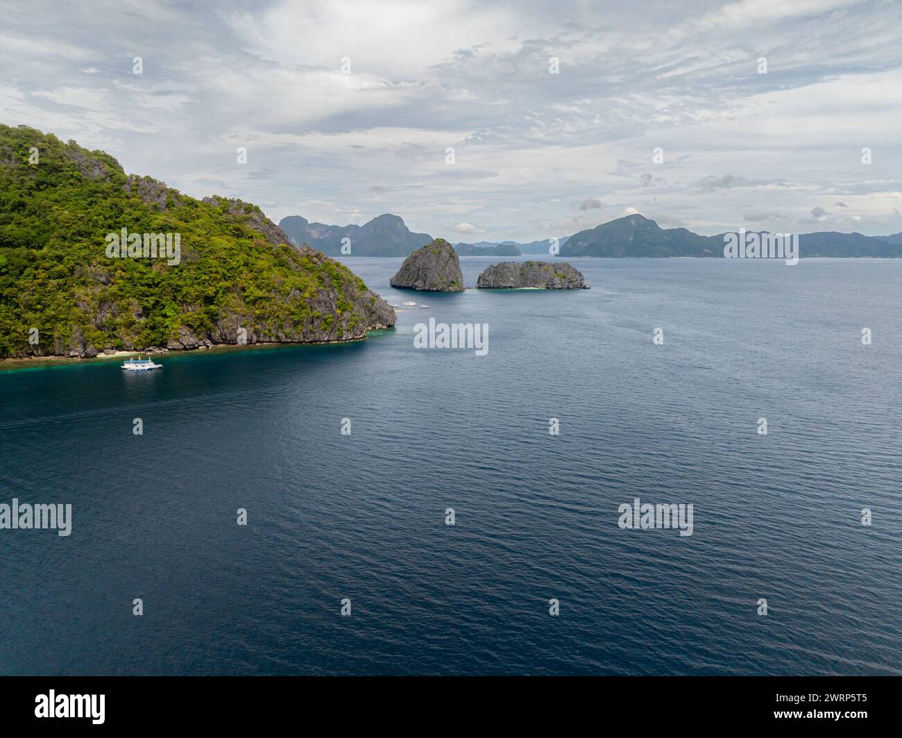 Boat on blue sea in Miniloc Island. Twin Rocks. El Nido, Palawan ...