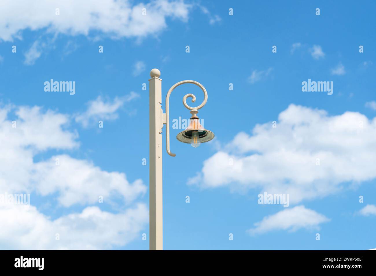 Old design Street light against blue sky background Stock Photo - Alamy