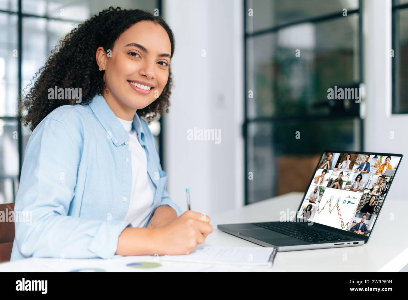 Positive hispanic businesswoman, ceo, sits at workplace in the office ...