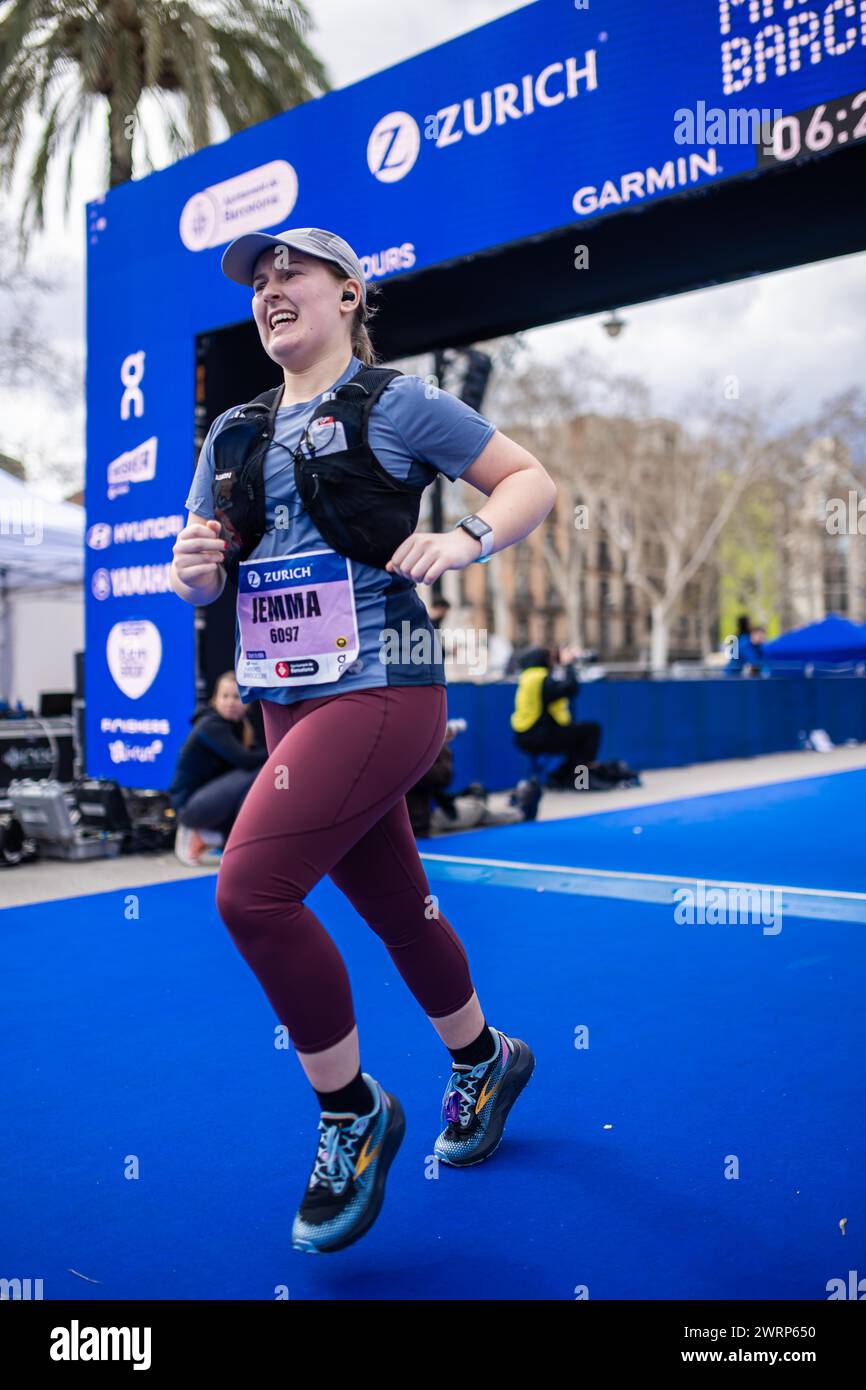Runners happily reaching the finish line in the Barcelona Marathon in ...