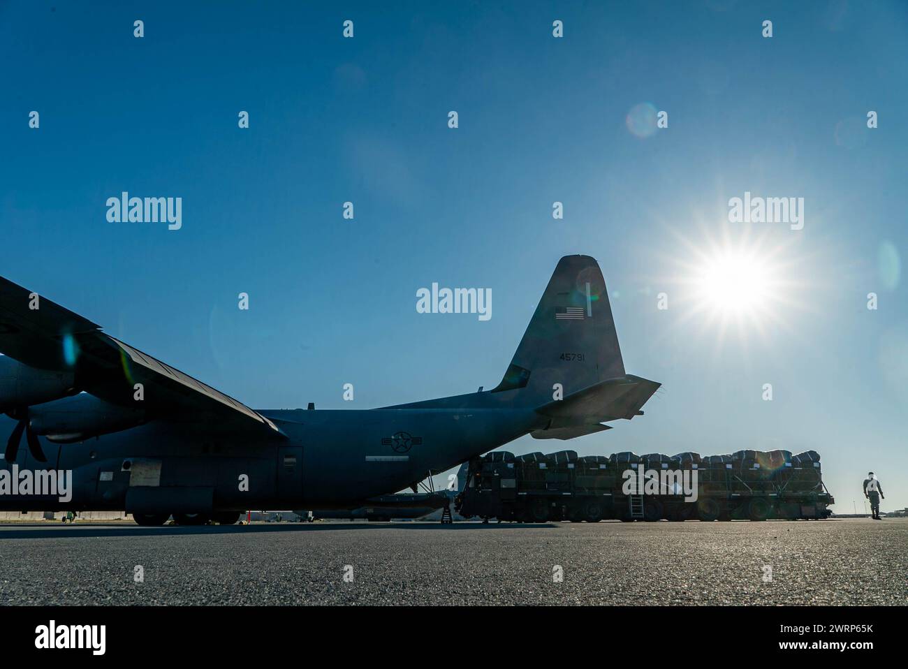 U.S. Air Force loadmasters and port operations Airmen load pallets of ...