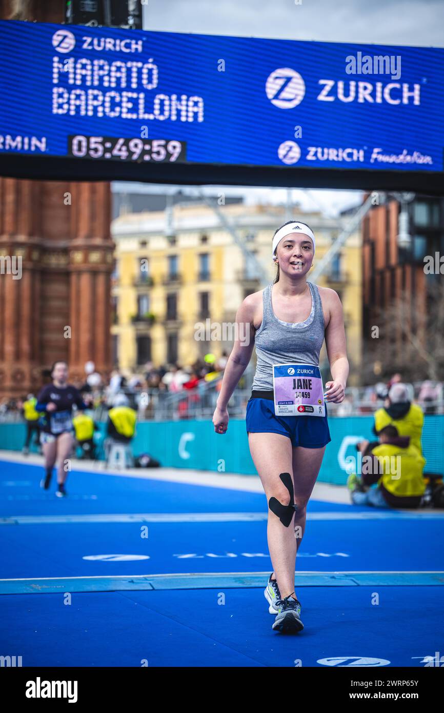 Runners happily reaching the finish line in the Barcelona Marathon in ...