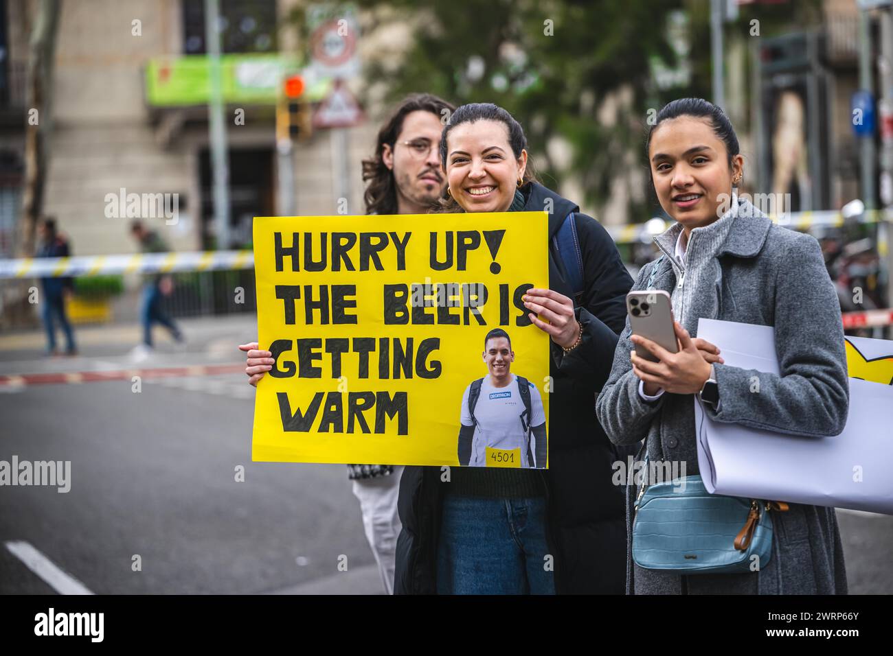 People cheering with posters at the Barcelona Marathon in 2024 Stock ...