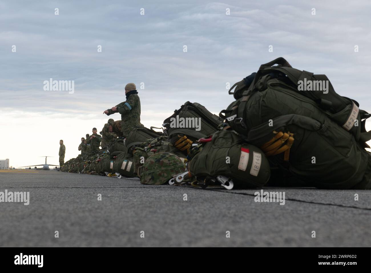 Japan Ground Self-Defense Force (JGSDF) paratroopers prepare to load ...