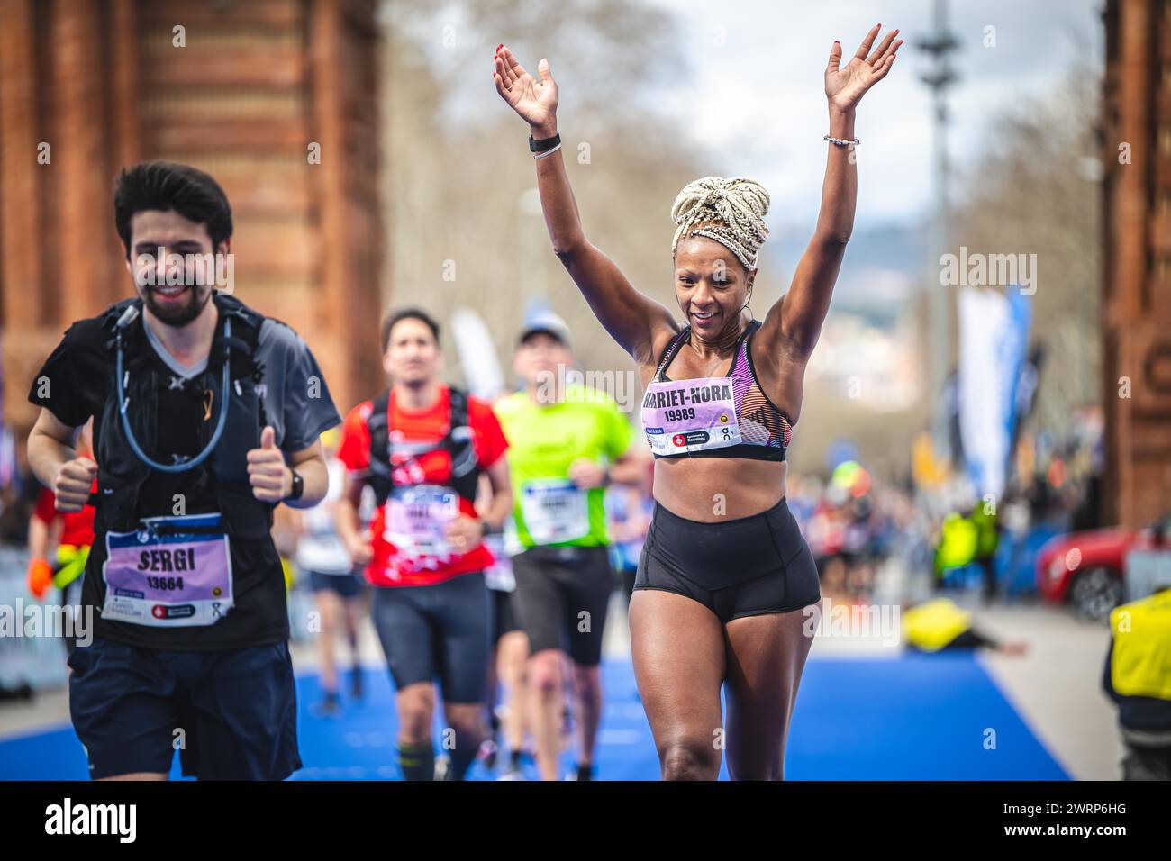 Runners happily reaching the finish line in the Barcelona Marathon in ...