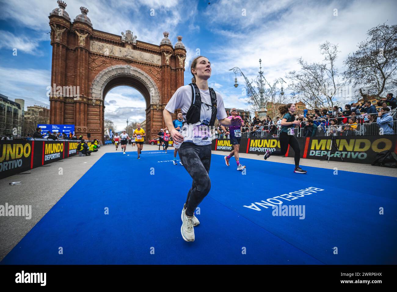 Runners happily reaching the finish line in the Barcelona Marathon in ...