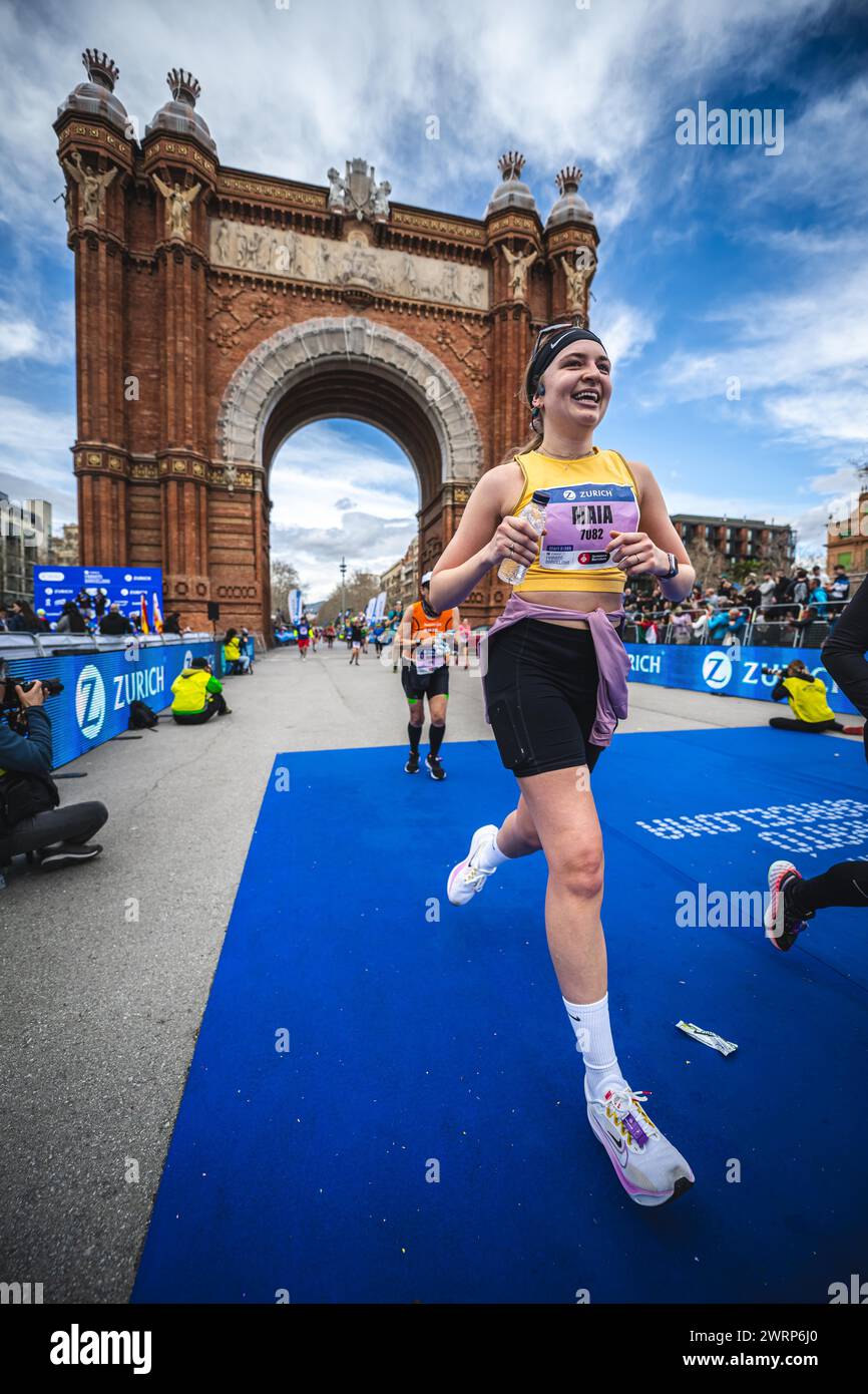 Runners happily reaching the finish line in the Barcelona Marathon in ...