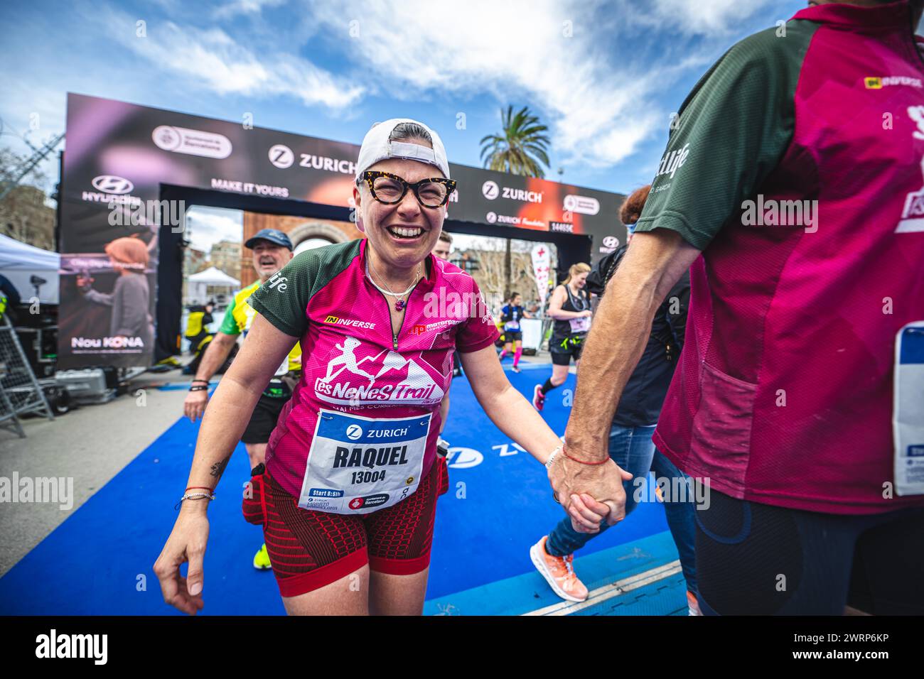 Runners happily reaching the finish line in the Barcelona Marathon in ...